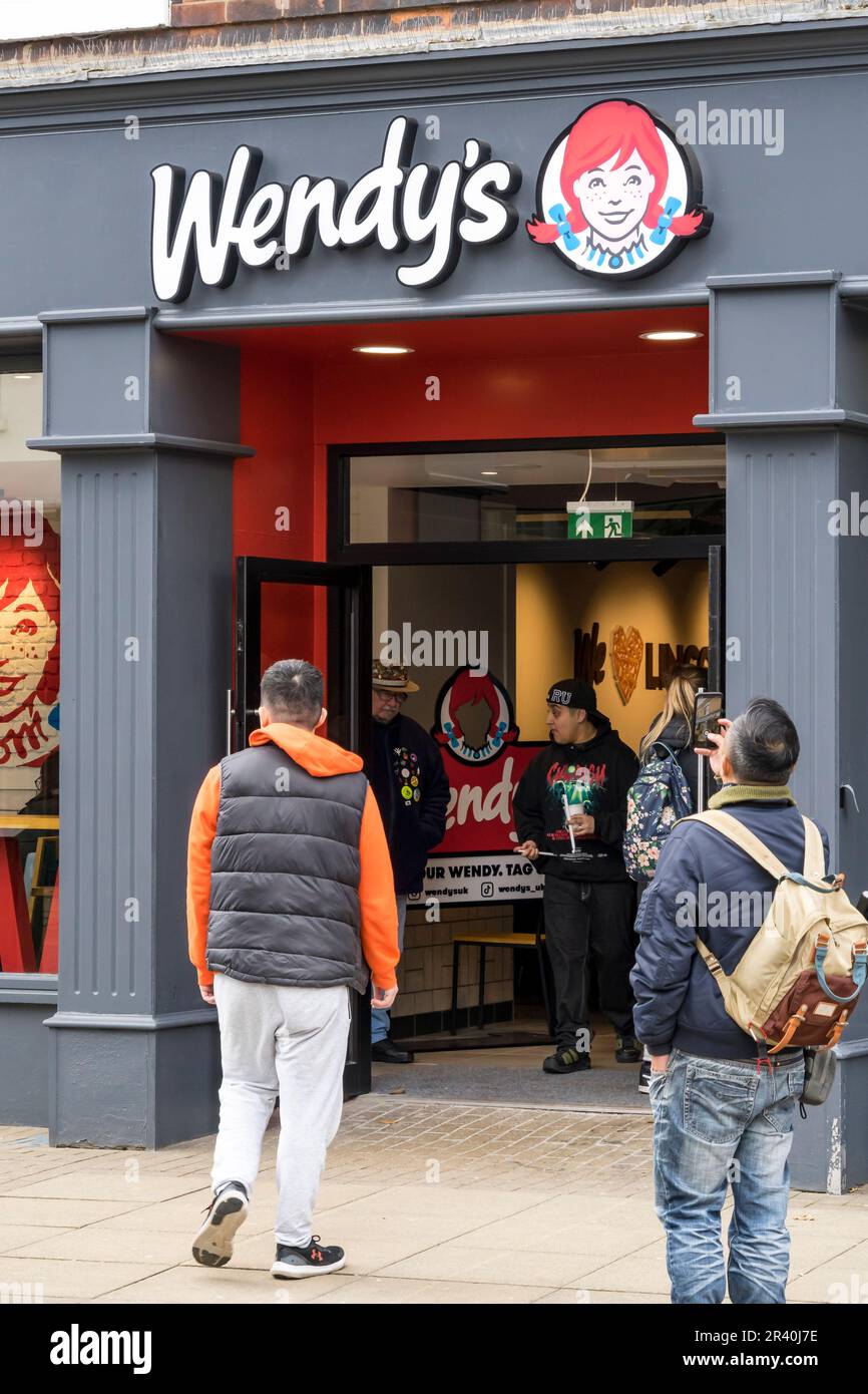 Man taking mobile photo of newly opened wendys burger restaurant hi-res ...