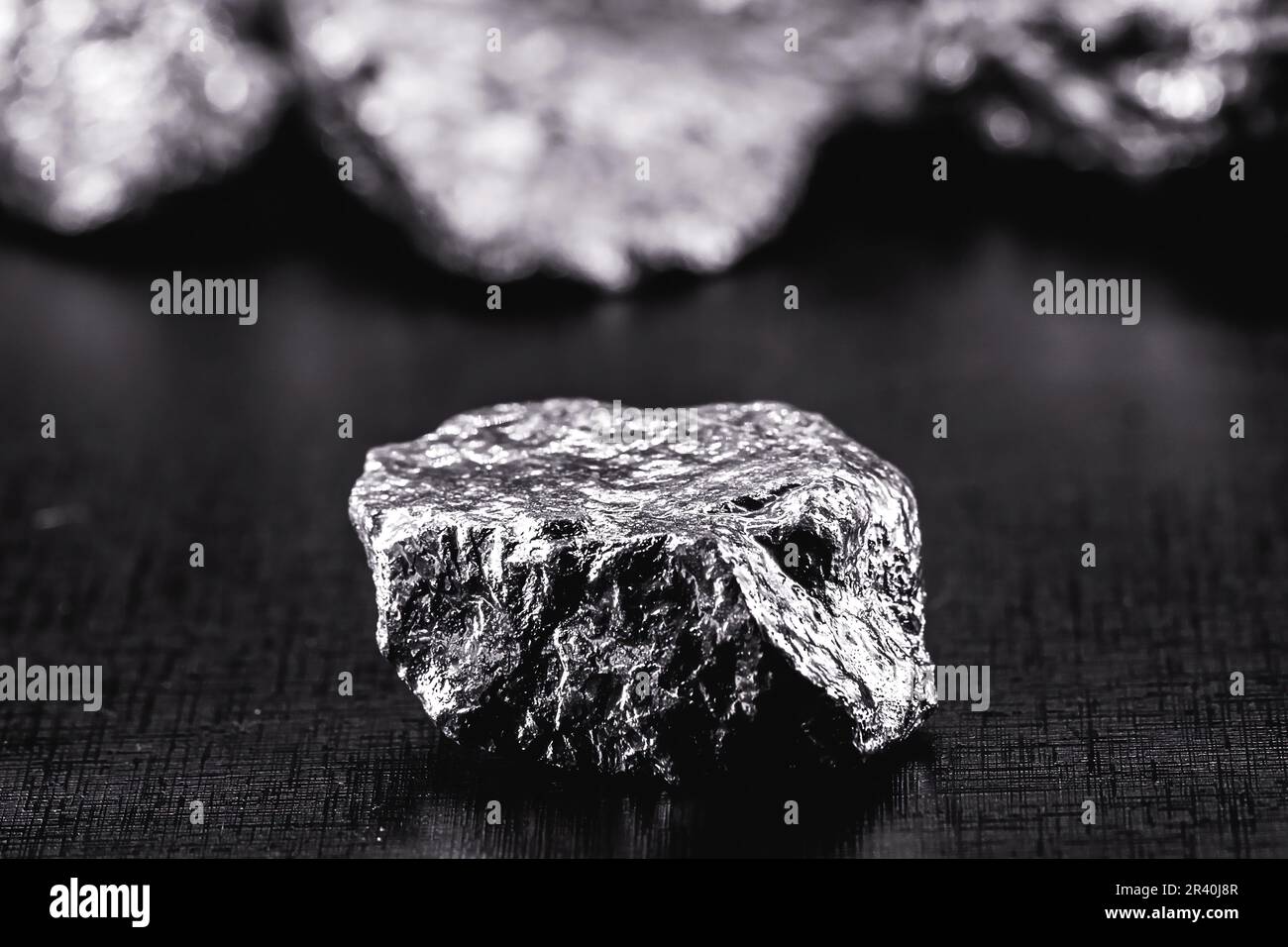 Manganese stones on electronic scale. Metal used in industry. Mineral ...