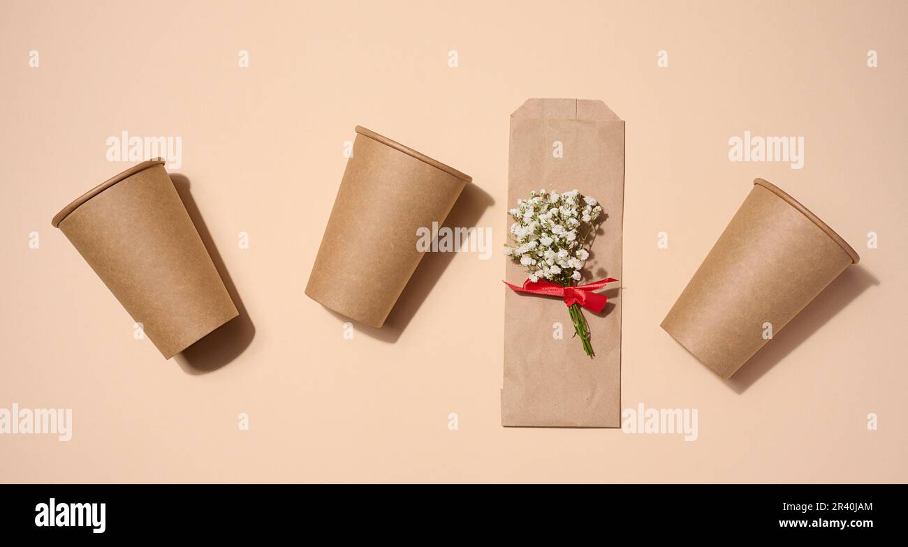 Empty brown paper disposable cups on a beige background, concept eco ...
