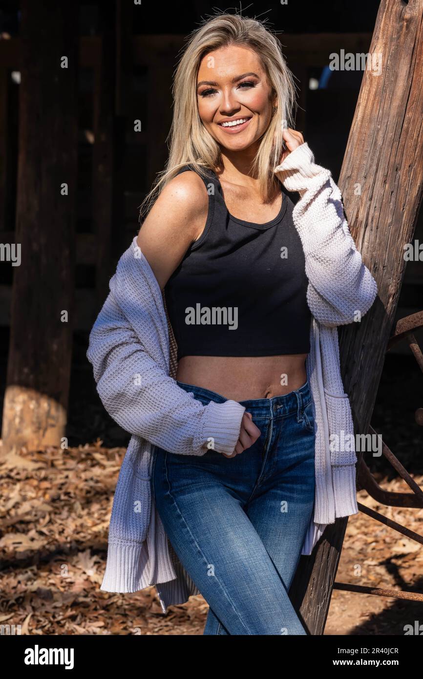 A Lovely Blonde Model In Western Gear Poses Outdoor While Enjoying The Spring Weather Stock ...