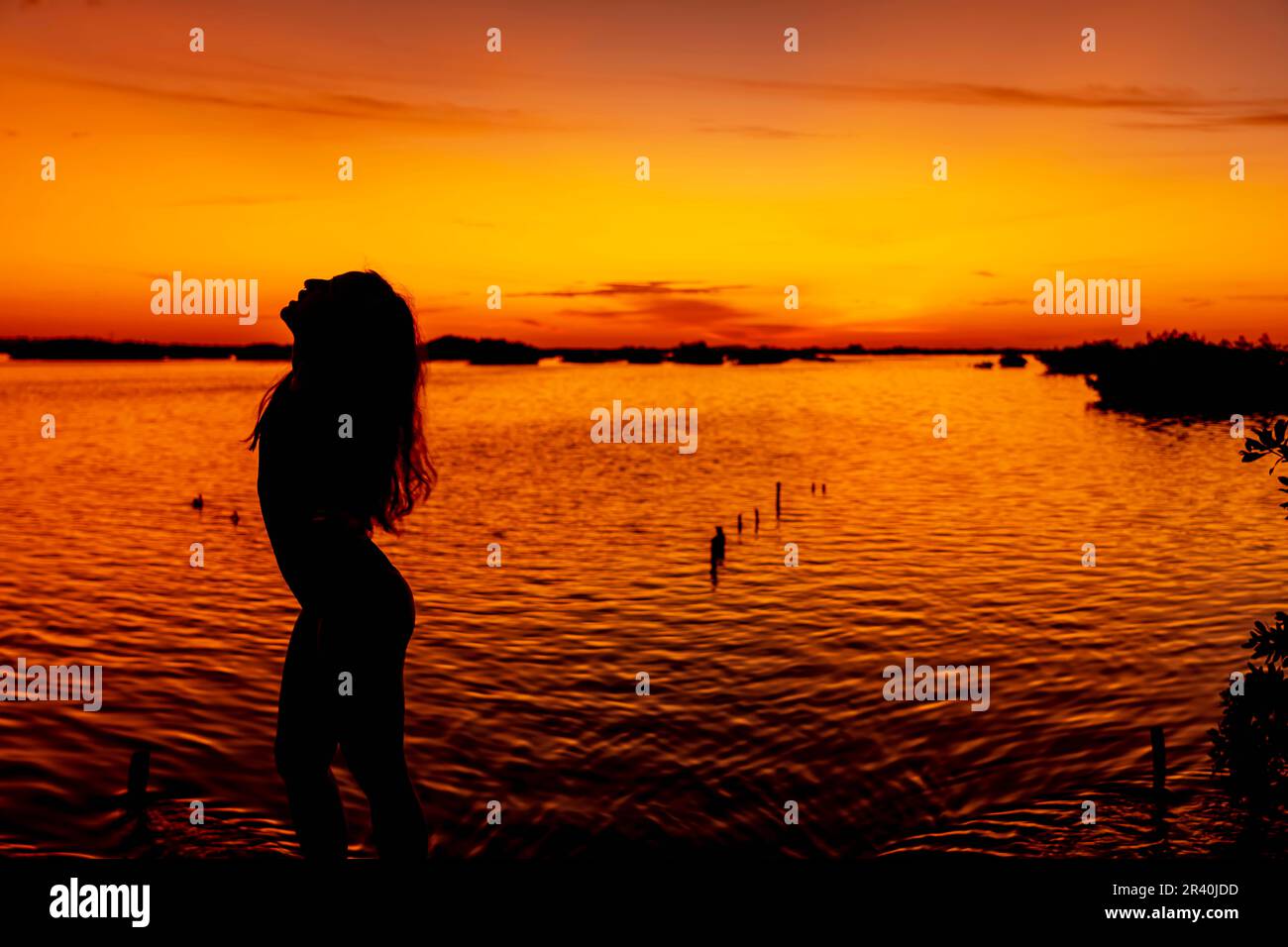 A Lovely Latin Model PosesAs The Sun Rises In The Caribbean Stock Photo ...