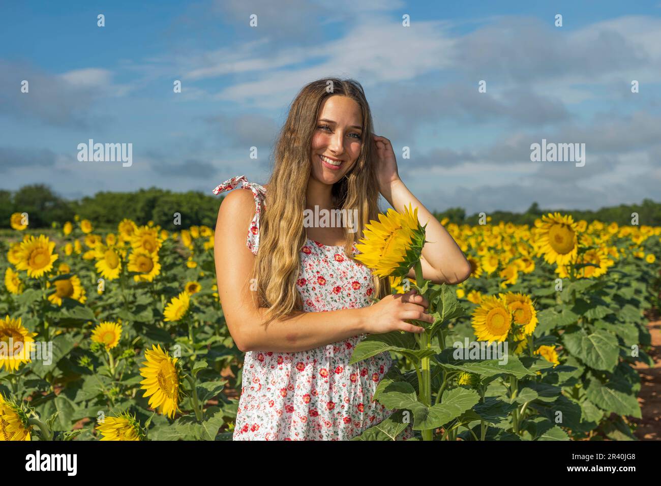 A Lovely Blonde Model Poses Outdoor While Enjoying The Summer Weather ...