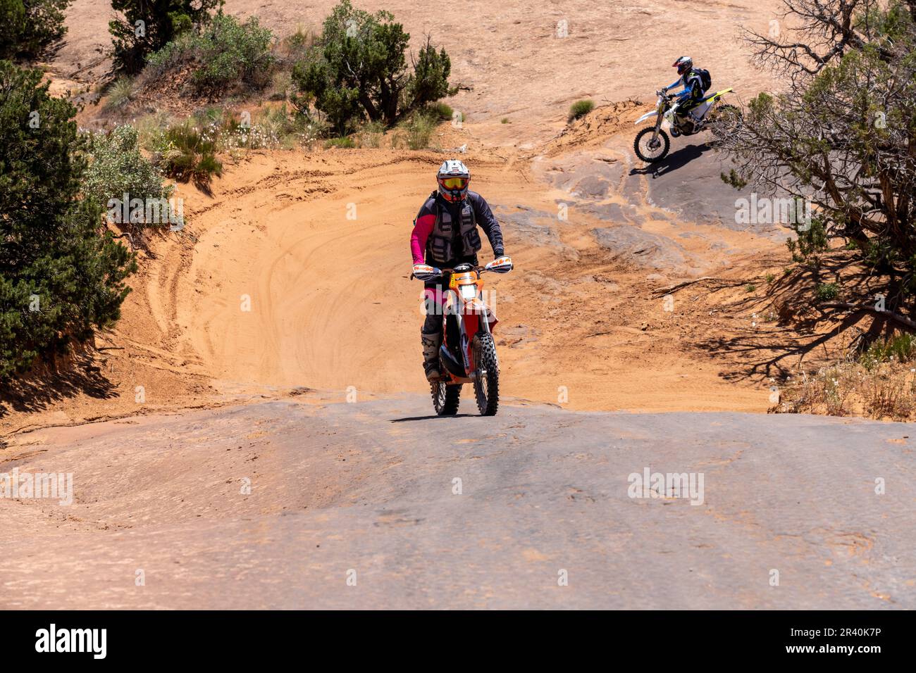 Off road motorcycle climbing a sandstone dome of the Fins & Things ...