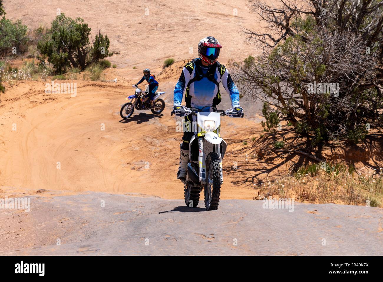 Off road motorcycle climbing a sandstone dome of the Fins & Things ...