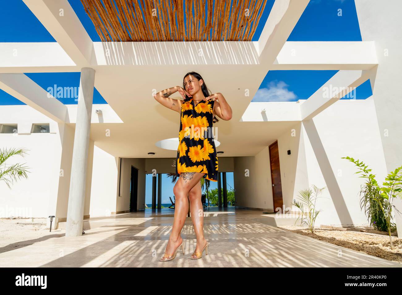 A Lovely Latin Model Poses Under A Bamboo Ceiling, Making Beautiful ...
