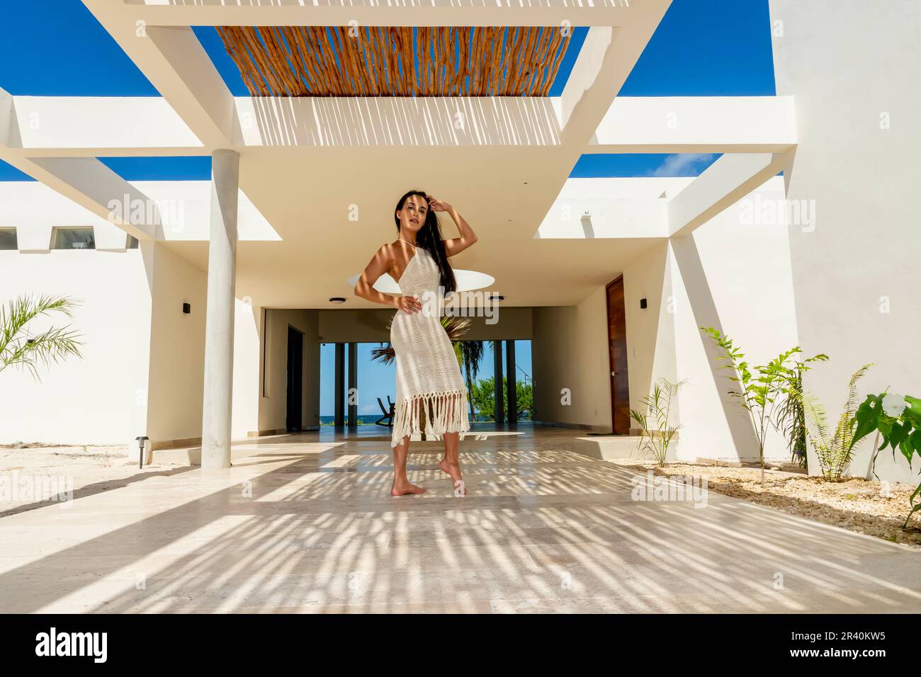 A Lovely Latin Model Poses Under A Bamboo Ceiling, Making Beautiful ...