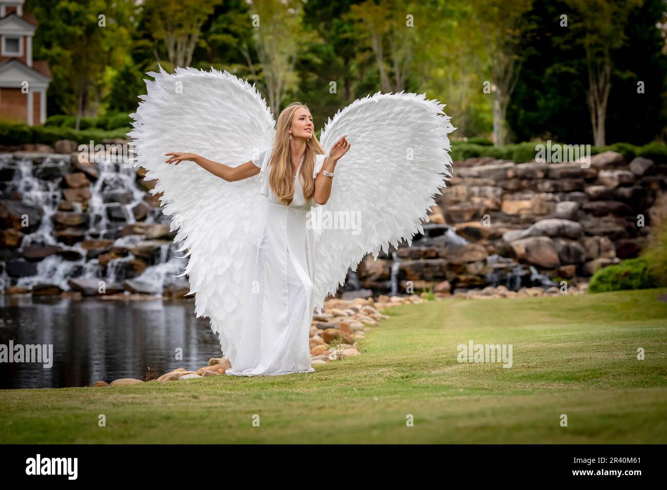 A Lovely Blonde Model Poses Outdoors While Wearing White Handmade Wings ...
