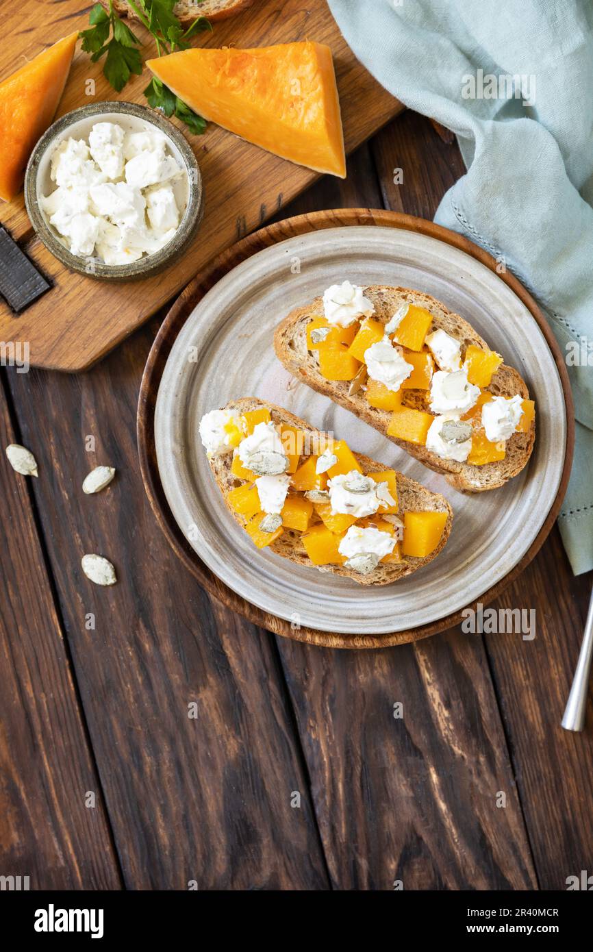Healthy food, vegetarian appetizer on a rustic table. Open sandwiches ...