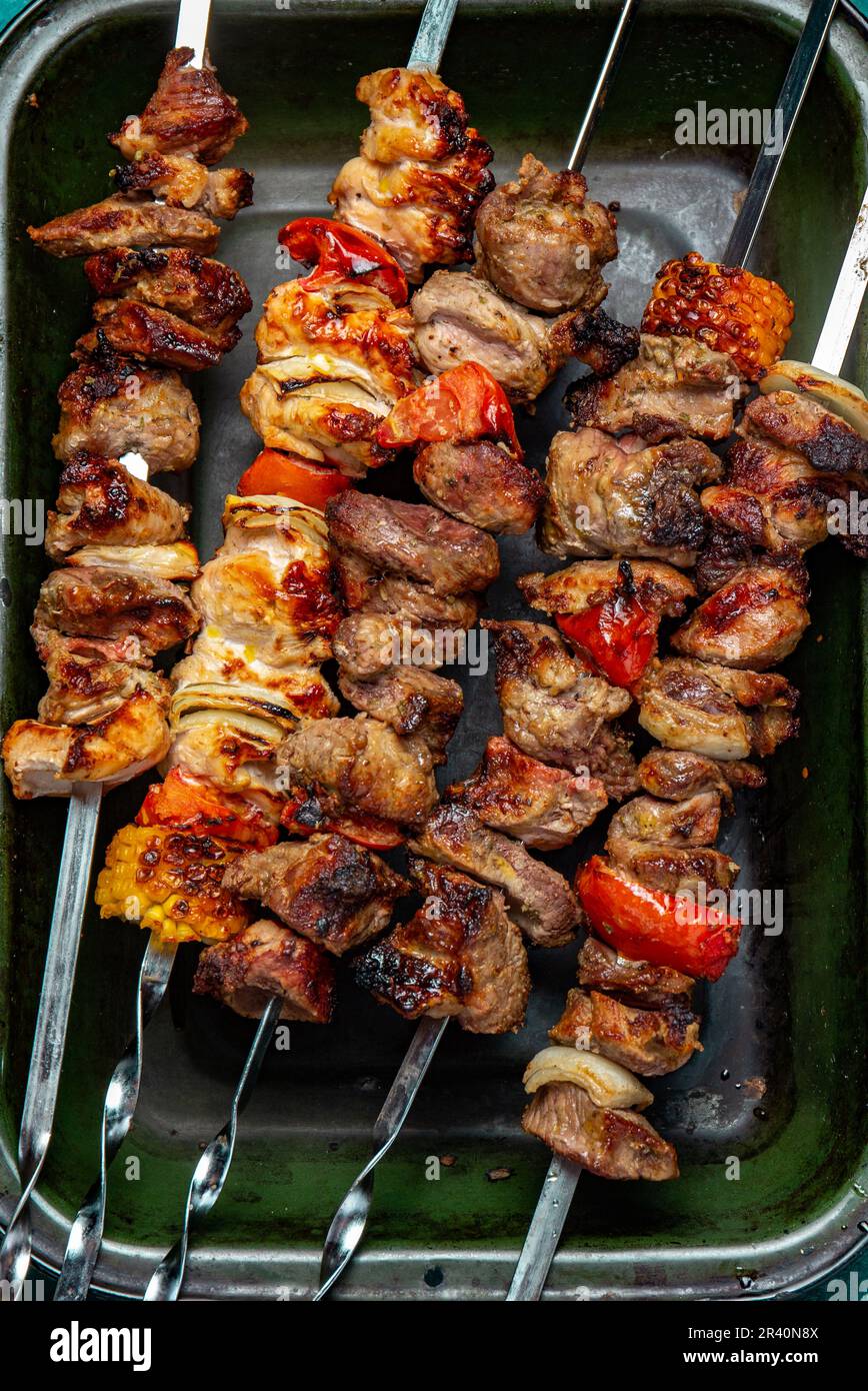 Bbq grilled meat pork, chicken and vegetable skewers on tray. Top view ...