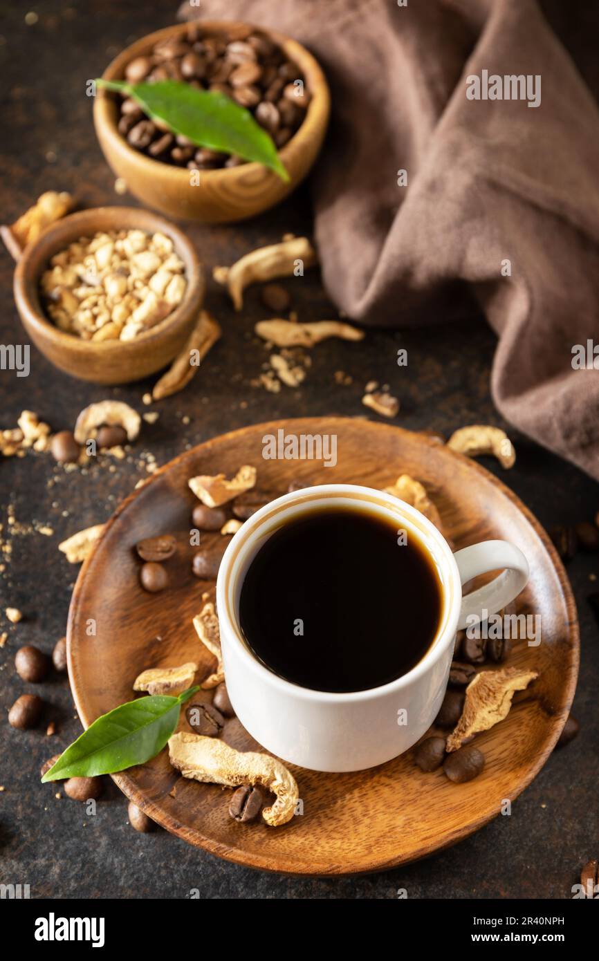 Mushroom coffee in a cup and coffee beans, trendy drink on a stone ...