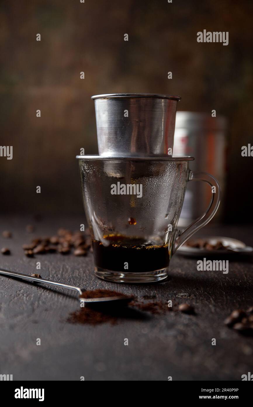 Preparation of Vietnamese coffe with aluminum cofe filer on dark ...