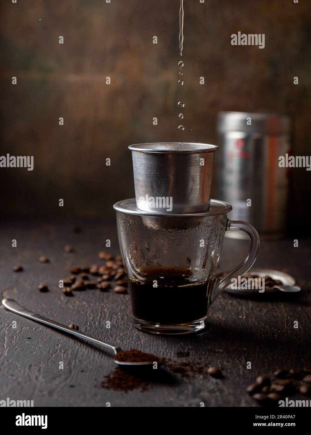 Preparation of Vietnamese coffe with aluminum cofe filer on dark ...