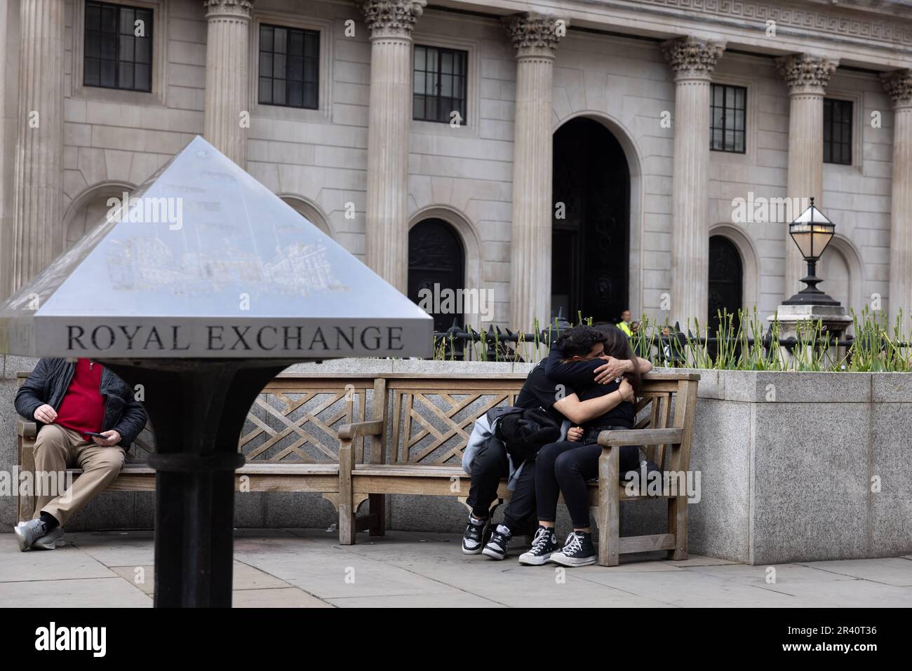 Couple sharing an intimate moment whilst sat outside the Royal Exchange ...