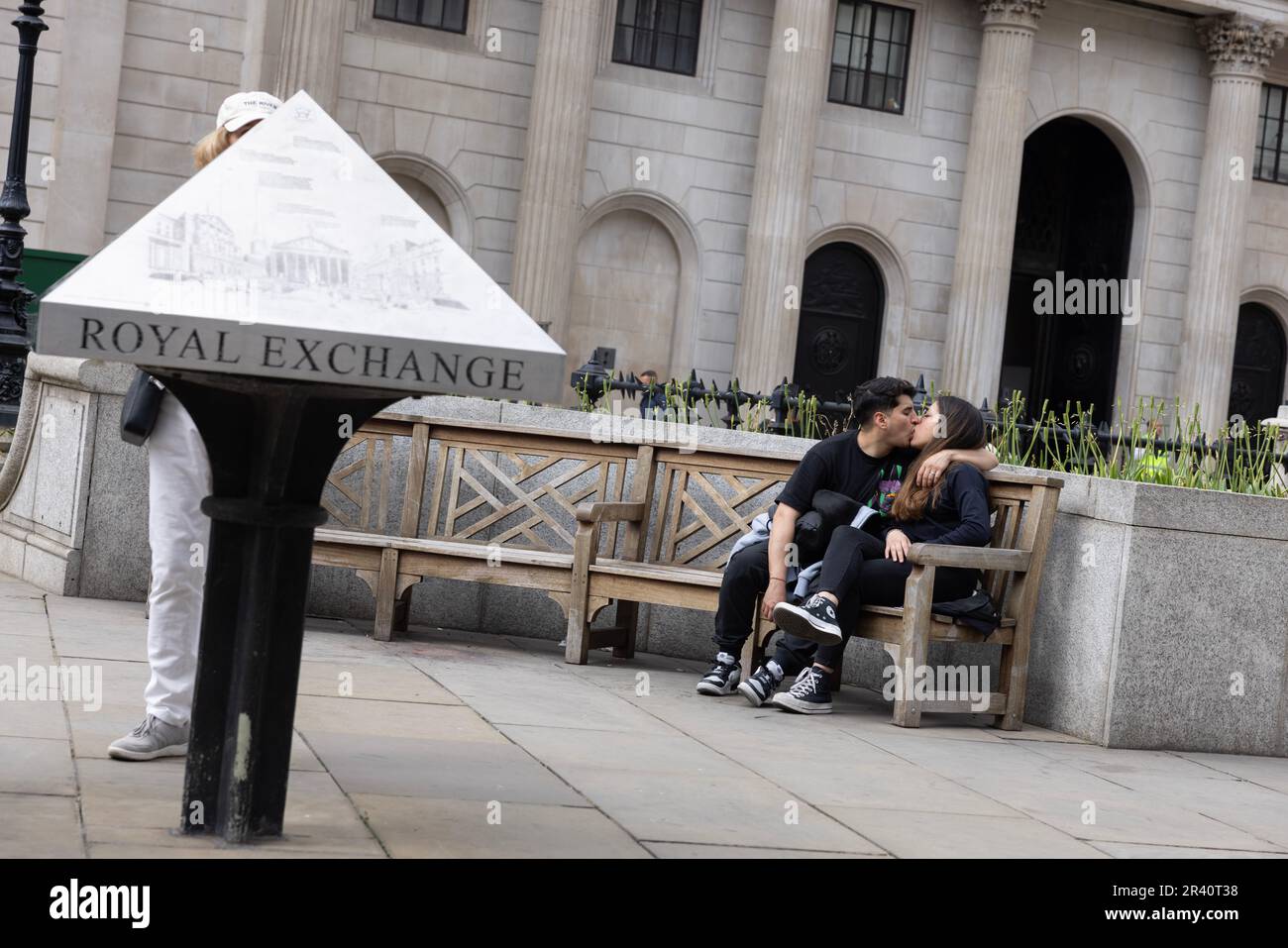 Couple sharing an intimate moment whilst sat outside the Royal Exchange ...