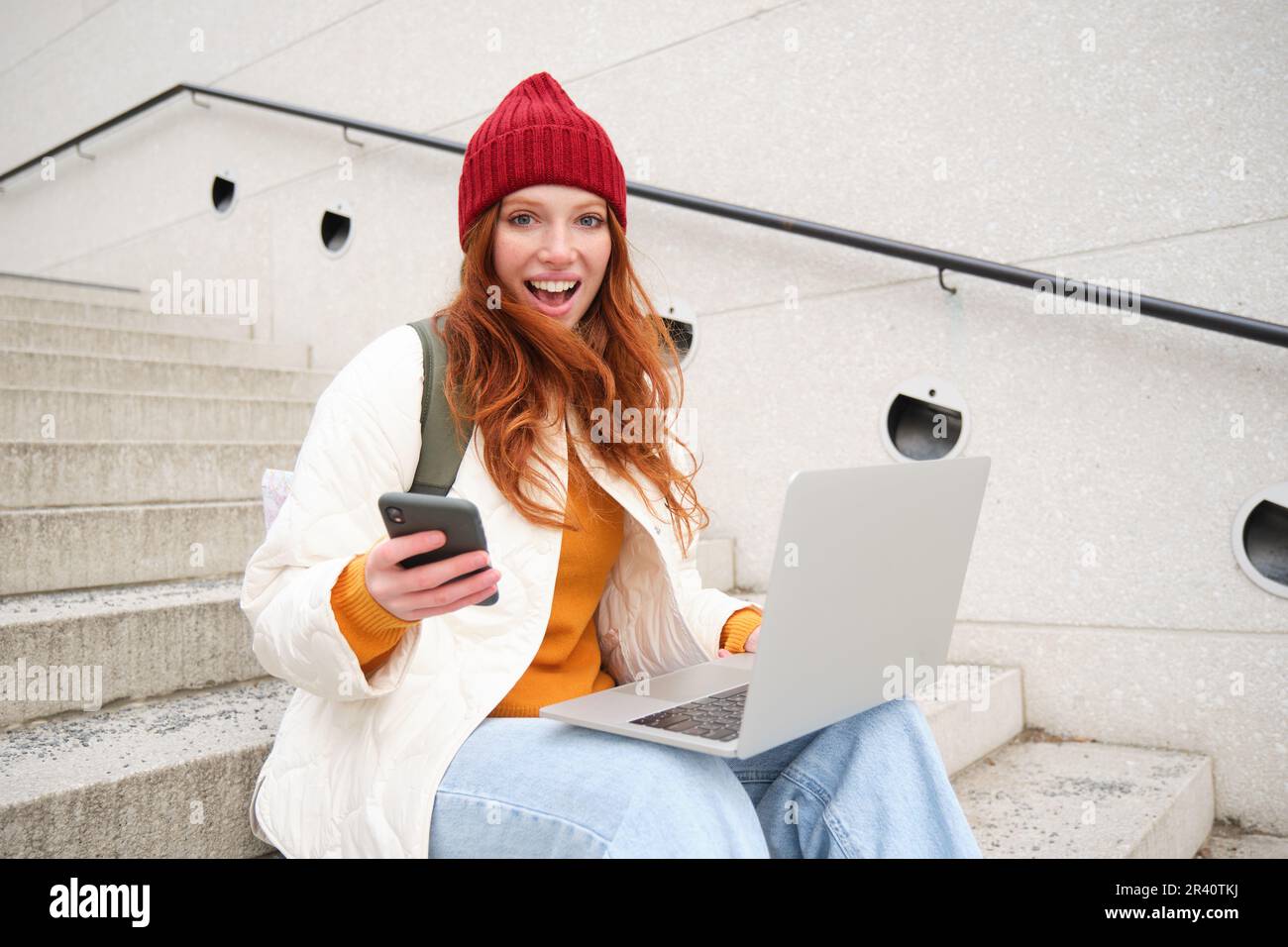 Young tourist, girl booking hotel room on laptop, enters confirmation ...