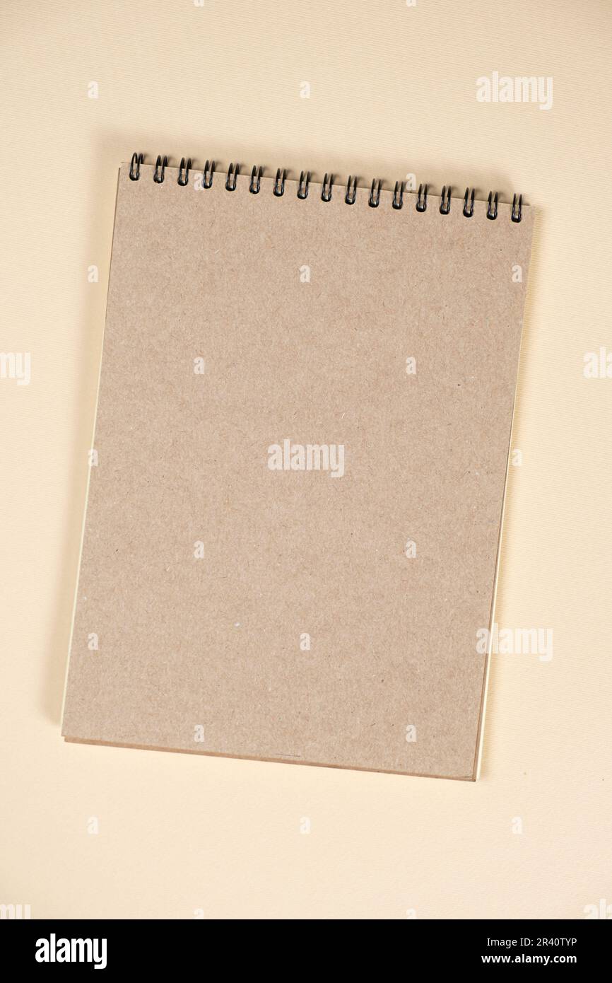 Notepad on a beige background top view, space for text Stock Photo - Alamy