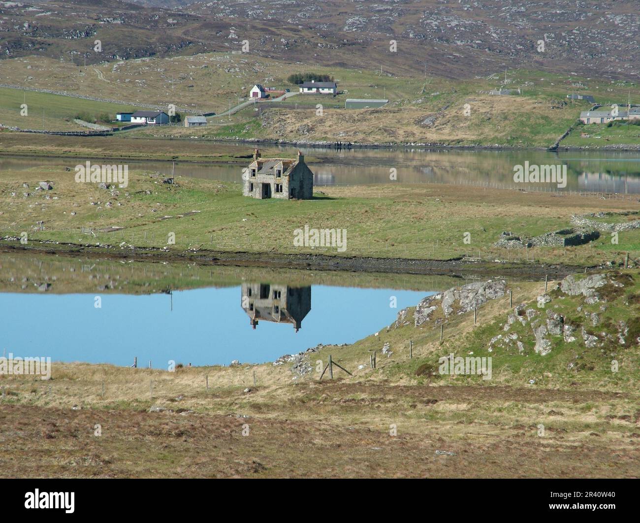 Reflection of an abandoned house on an island in the Outer Hebrides. A ...