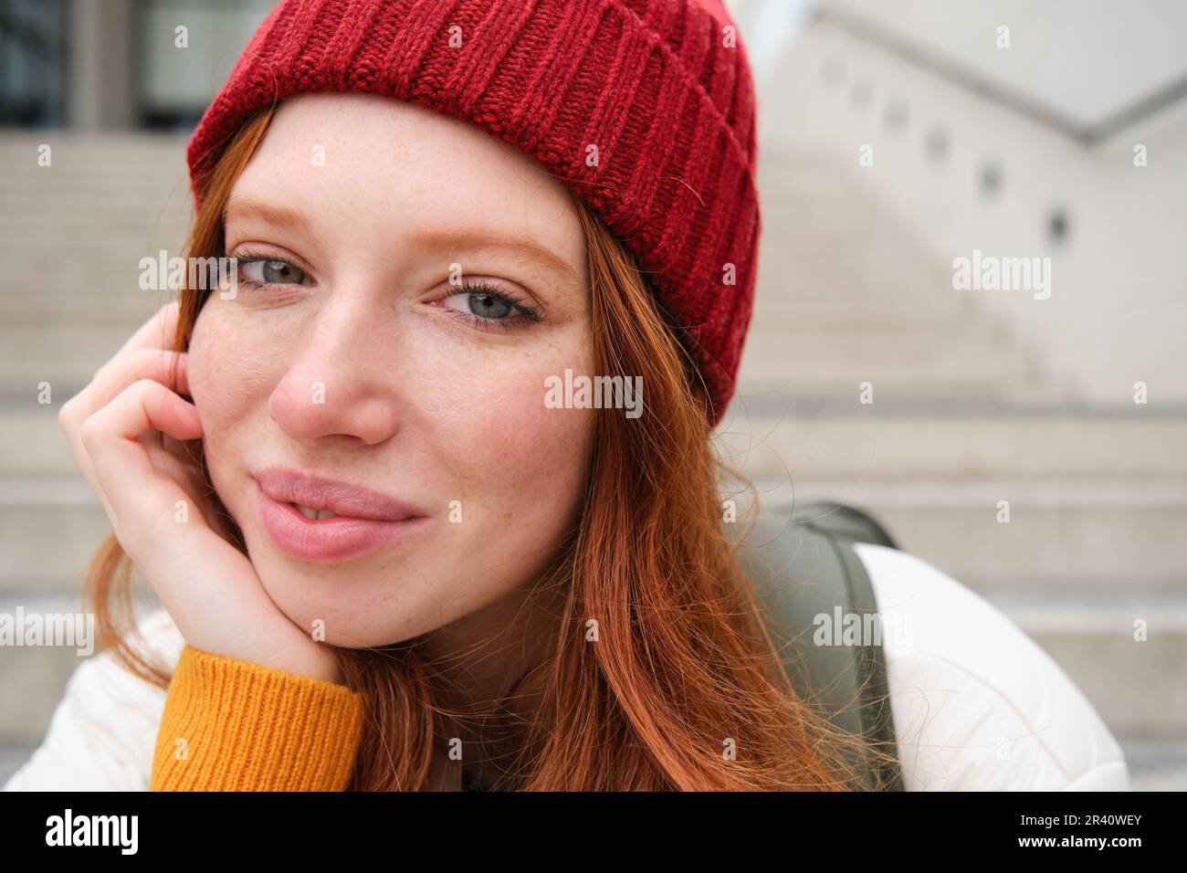Close up portrait of beautiful redhead girl in red hat, urban woman ...