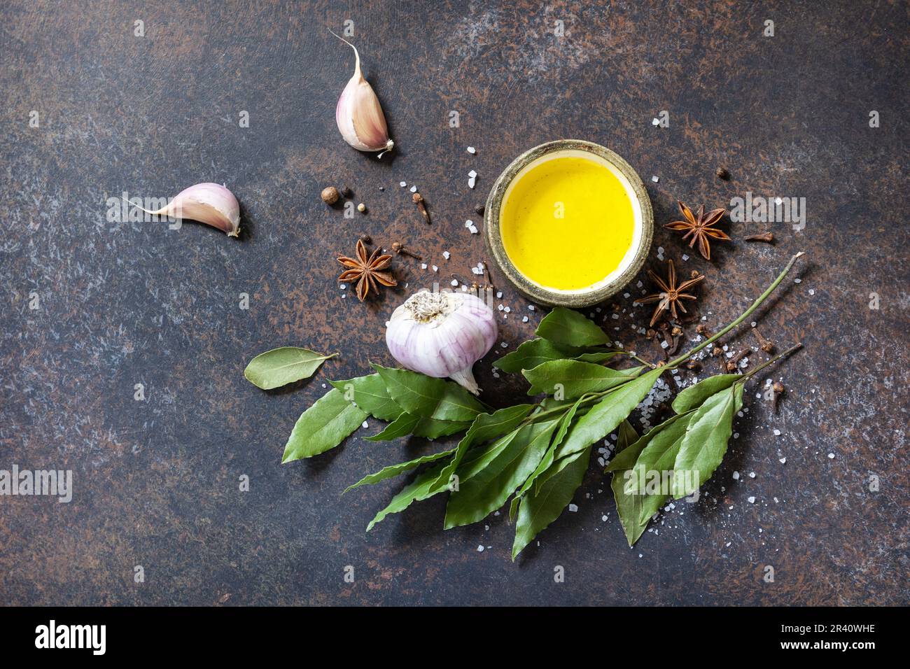 Culinary food background. Bay leaves with garlic, rosemary, bay leaves ...