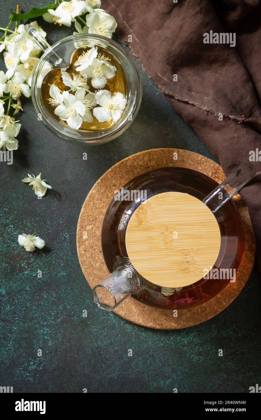 Therapeutic herbal tea. Hot green tea with jasmine flowers in a glass ...