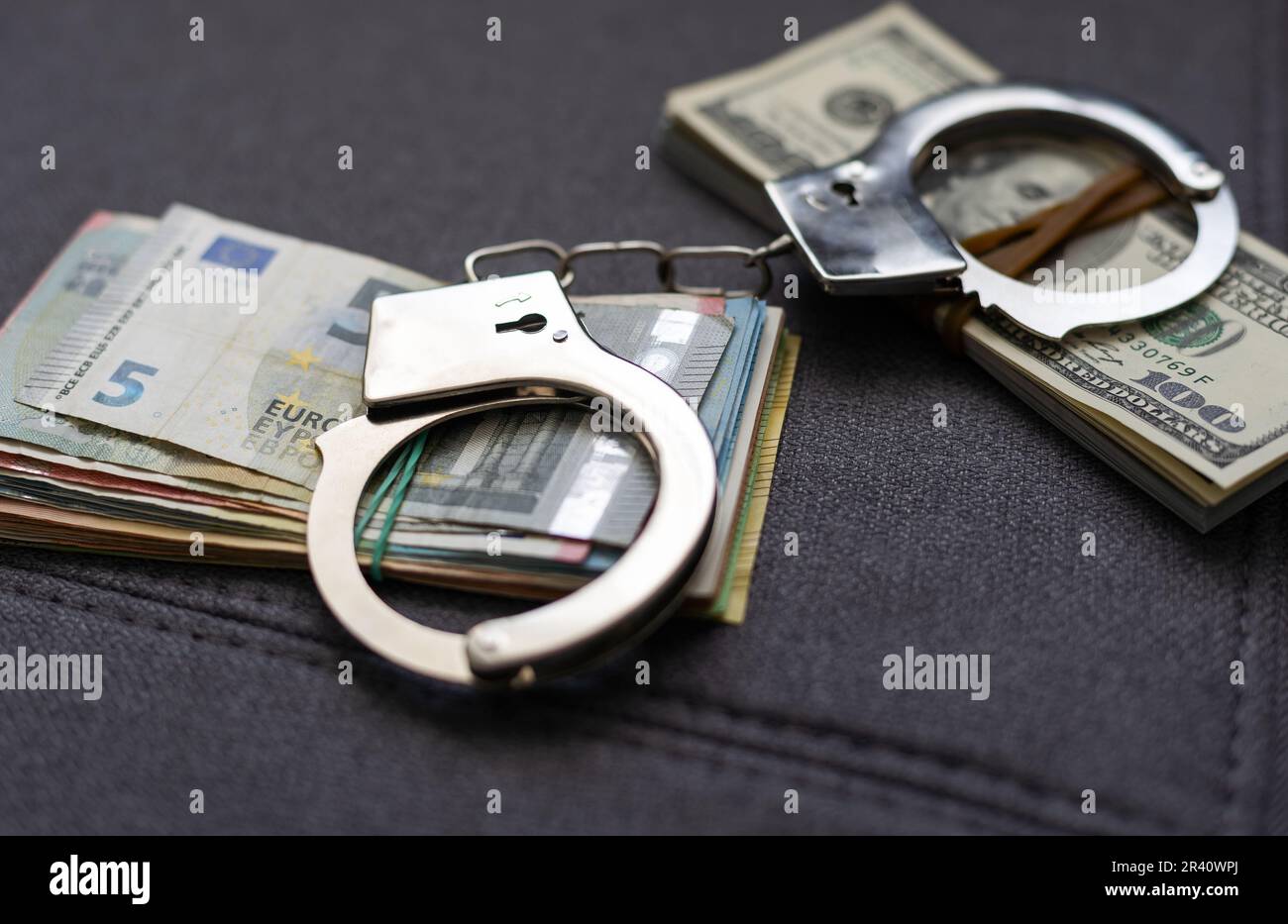 Banknotes dollars money and handcuffs isolated on black background ...