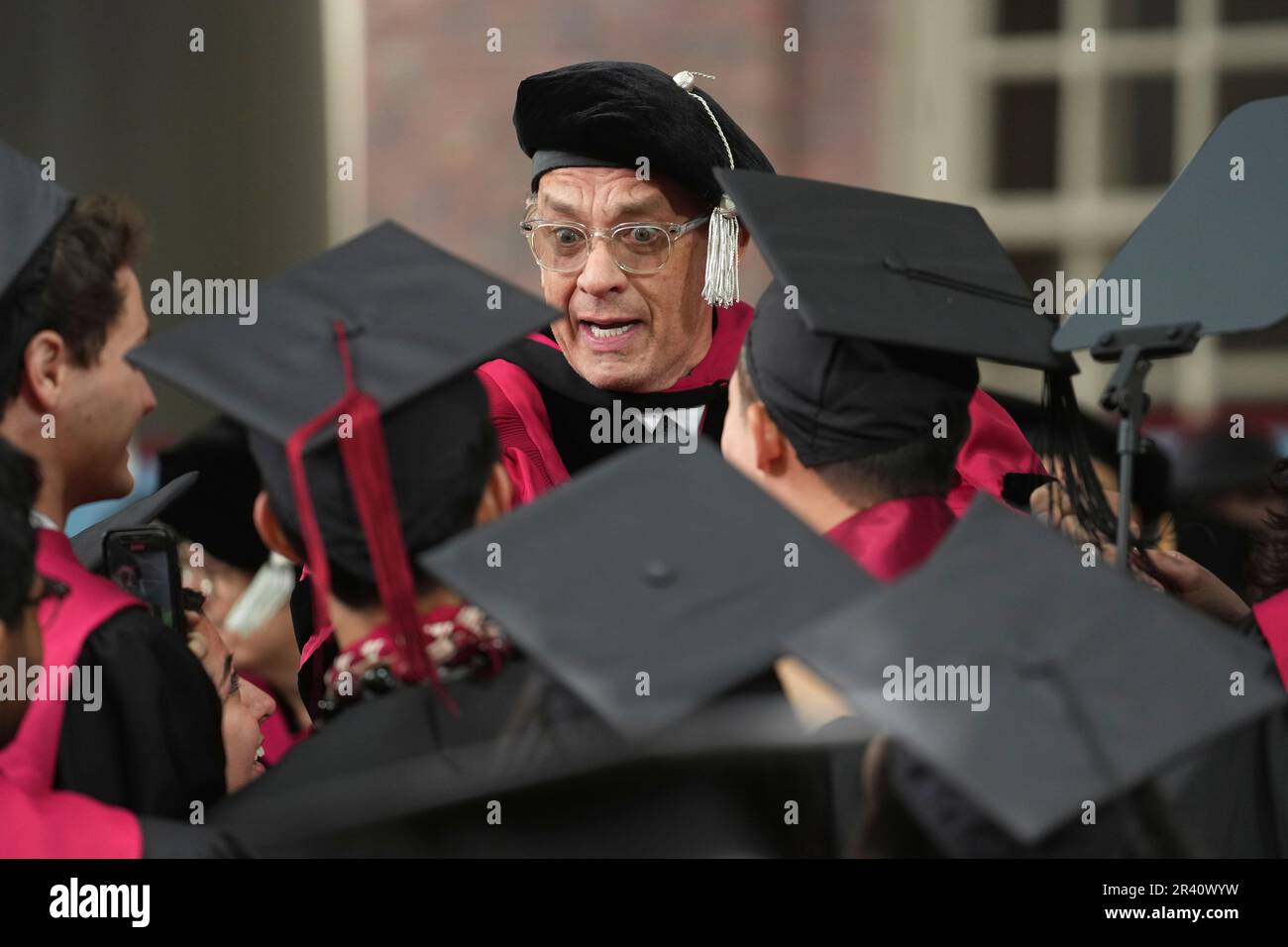 Actor Tom Hanks, center, greets graduating students during Harvard ...