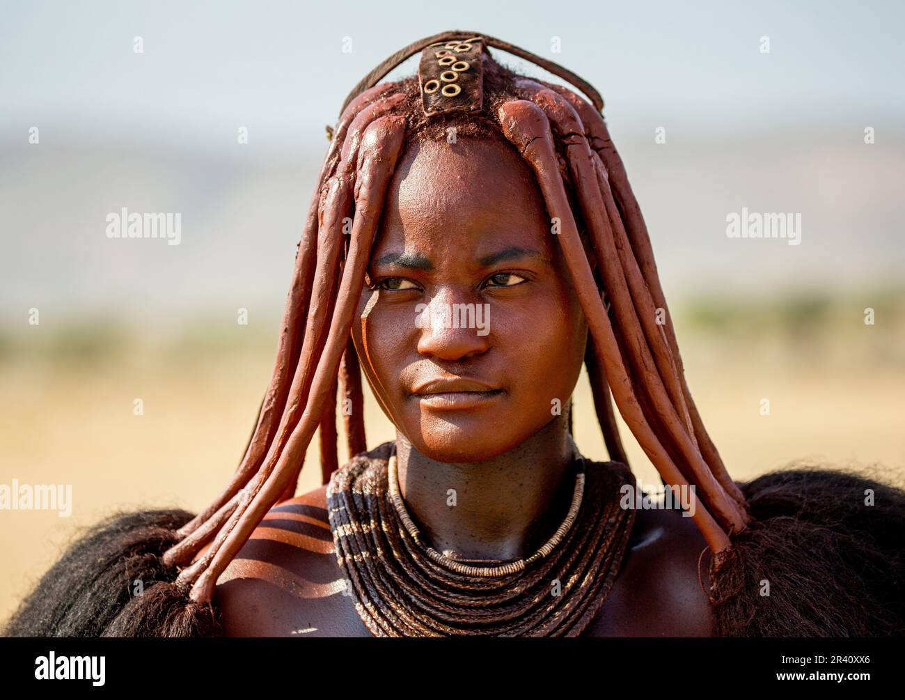 Portrait of a young woman of the Himba tribe with a traditional ...