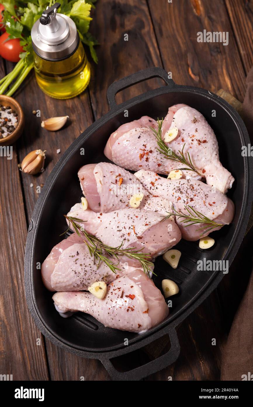Raw chicken meat. Uncooked chicken legs on wooden cooking table ...