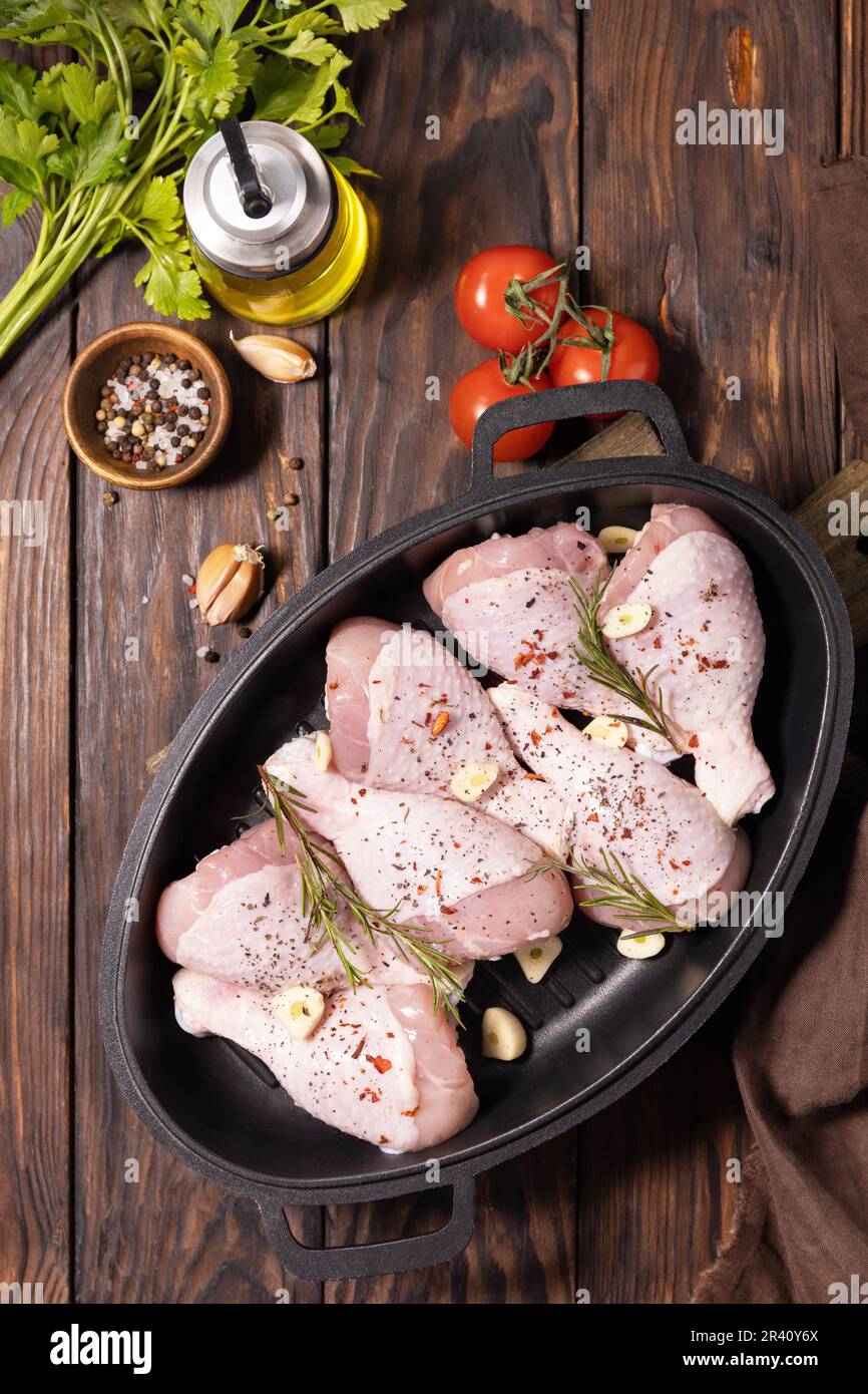 Raw chicken meat. Uncooked chicken legs on wooden cooking table ...