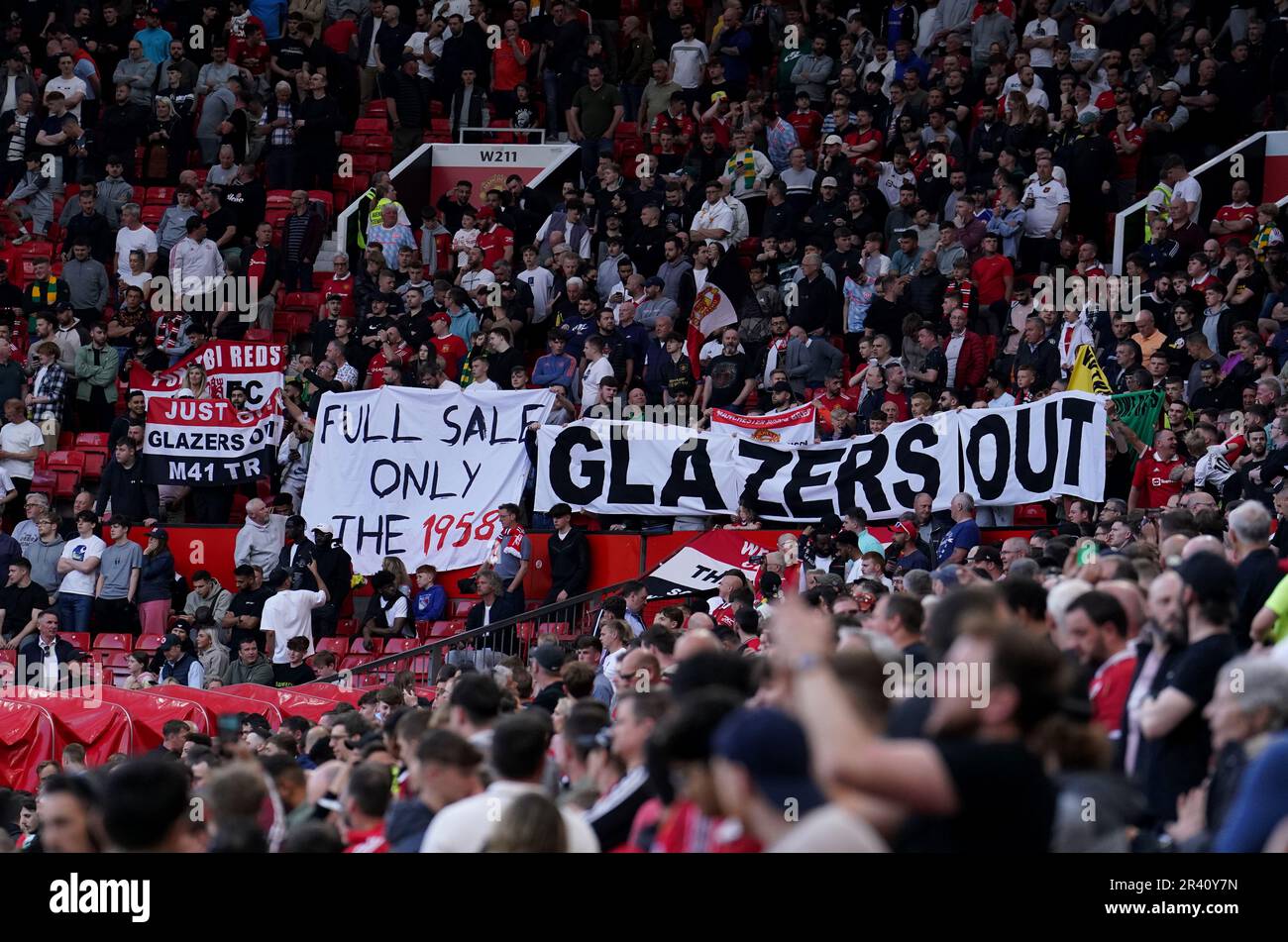 Manchester United fans hold up banners aimed at the club's ownership ...