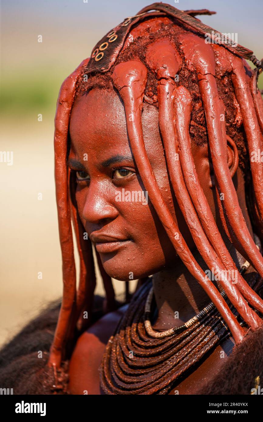 Portrait of a young woman of the Himba tribe with a traditional ...