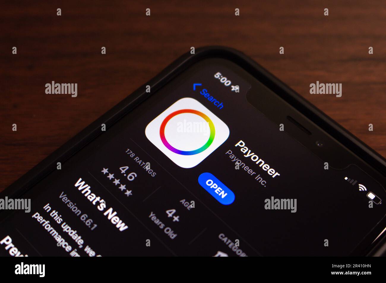 Payoneer app icon seen in an App Store on an iPhone screen. Payoneer is ...