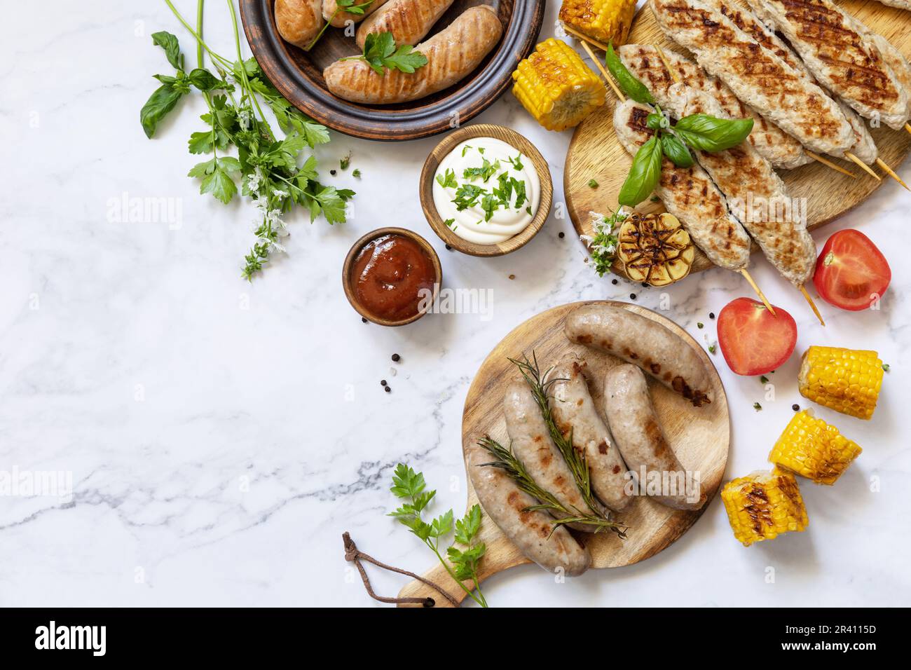 Grill food menu. Various bbq grilled sausages with fresh herbs and ...