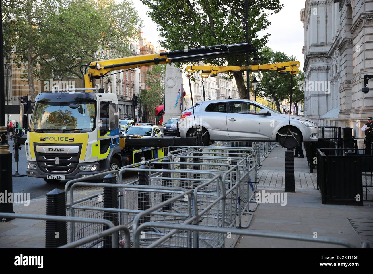A police recovery truck lifts a car after it collided with the gates of ...