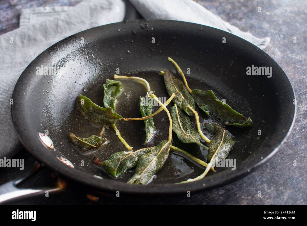 Sage Leaves Fried in a Non-Stick Skillet with Butter: Close-up view of ...