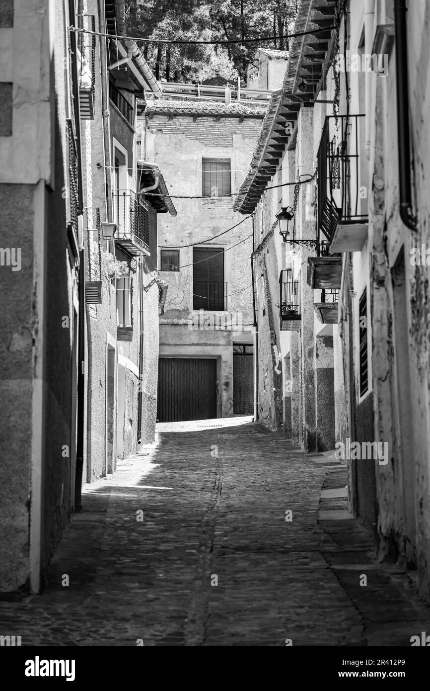 Narrow alley with old stone houses in the medieval town of Daroca ...