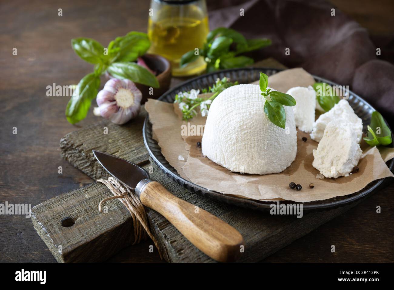 Homemade Italian ricotta cheese or cottage cheese with basil on a ...