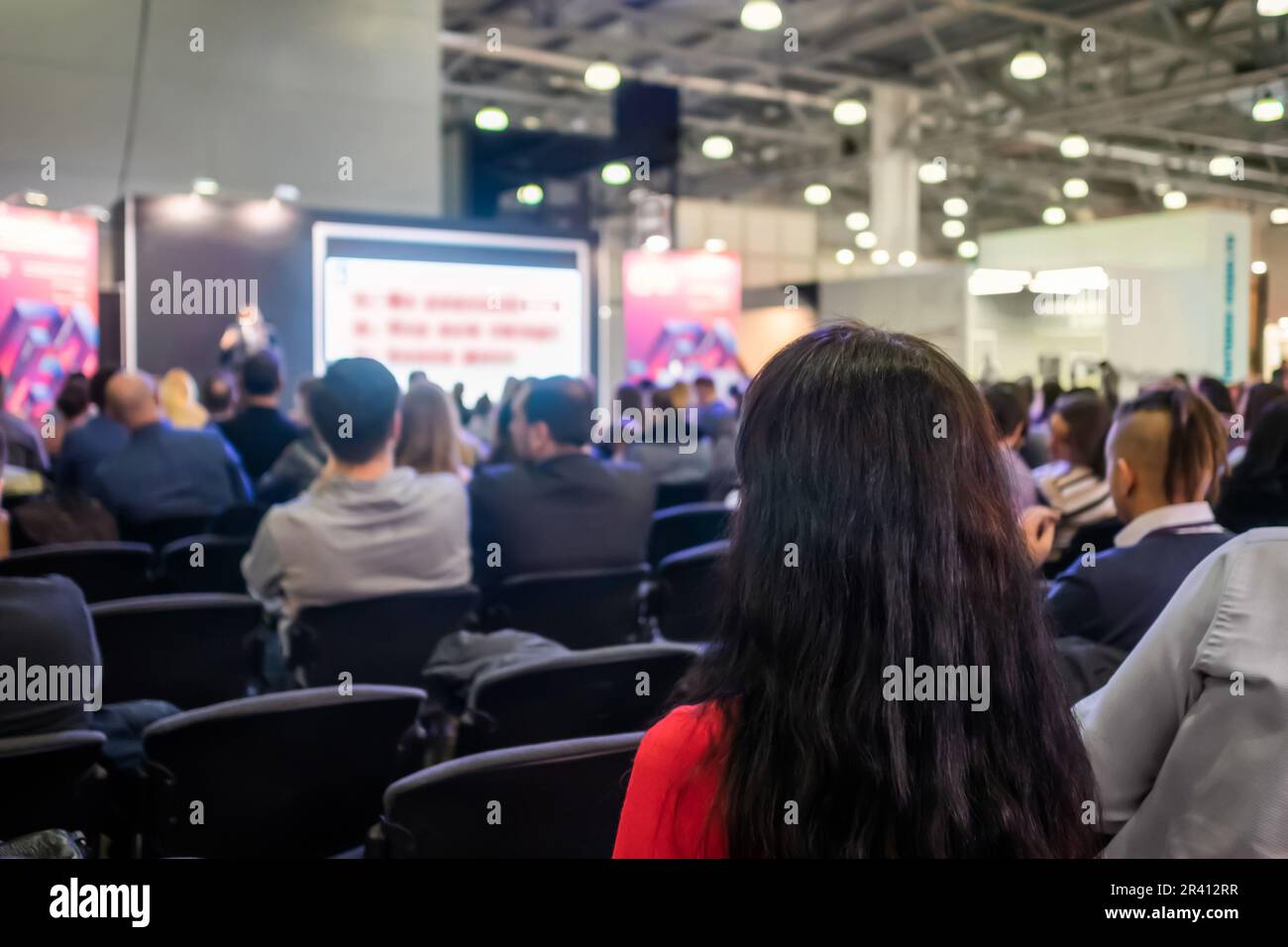 Back view of audience listening presentation at conference hall Stock ...