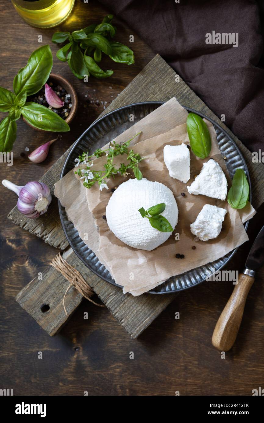 Homemade Italian ricotta cheese or cottage cheese with basil on a ...