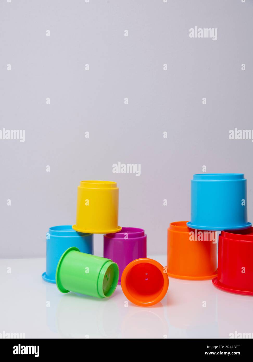 Colorful stacking plastic cups on white background.balance concept ...