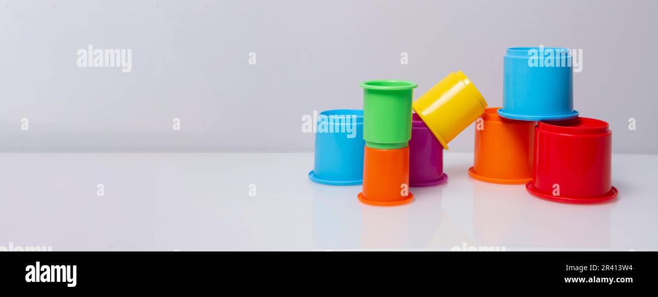 Colorful stacking plastic cups on white background.balance concept ...