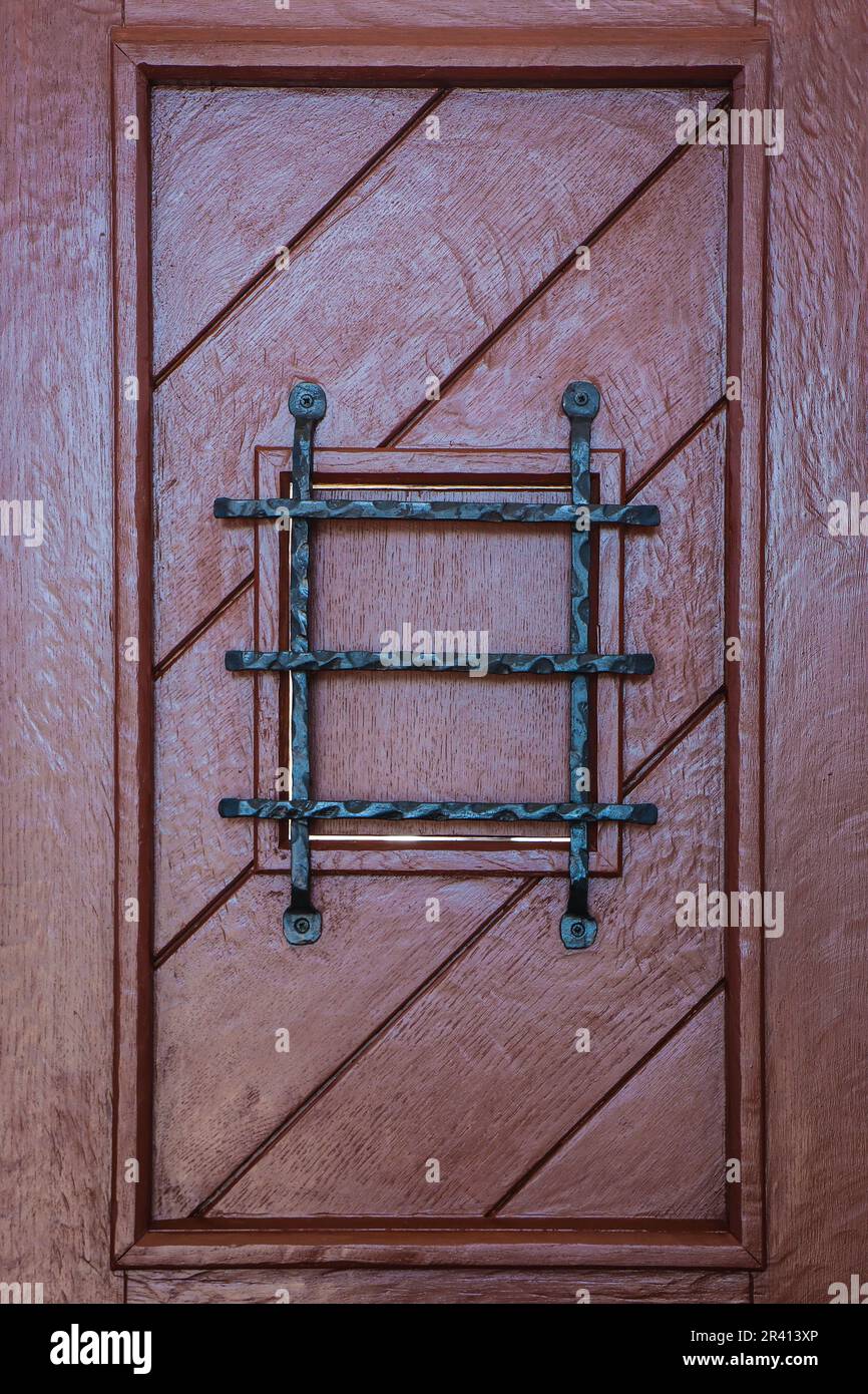 Wooden gate with barred window Stock Photo - Alamy