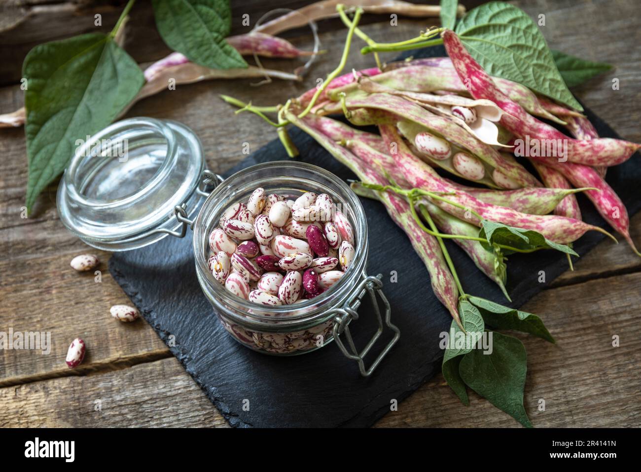 Beans of bean, brown bean (of dried beans) in a glass jar on a rustic ...