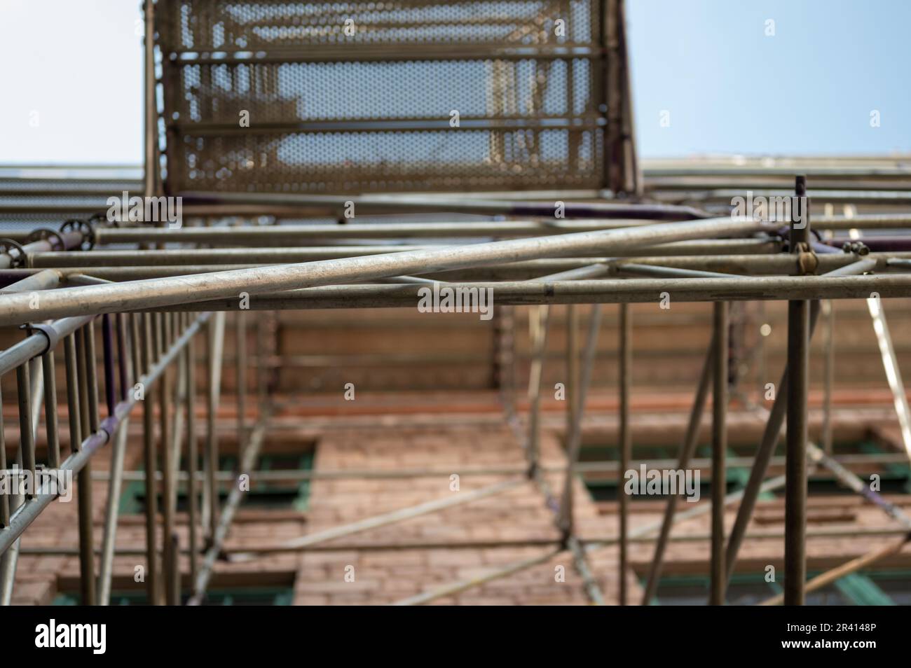 scaffolding erected along the outside of an old building looking up to ...