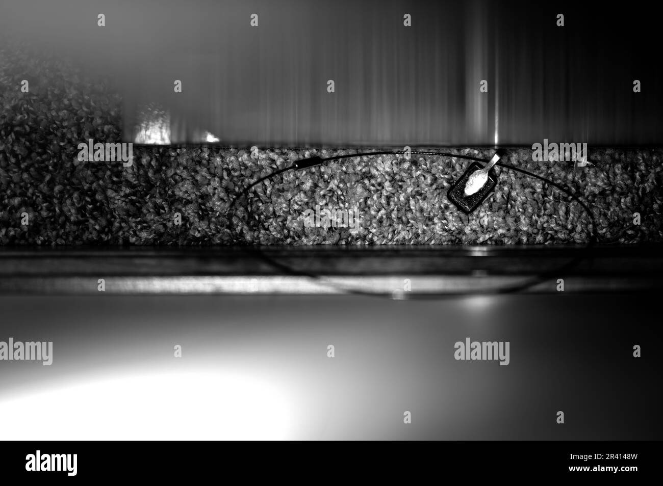 small object dropped behind furniture and trapped between a wall Stock ...