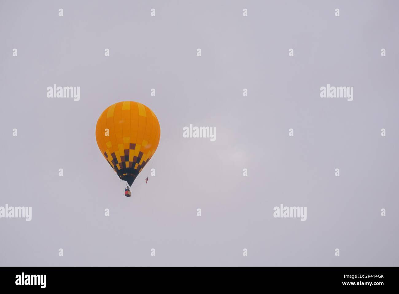 Colorful hot air balloon flying against grey sky at Winter aerostat ...