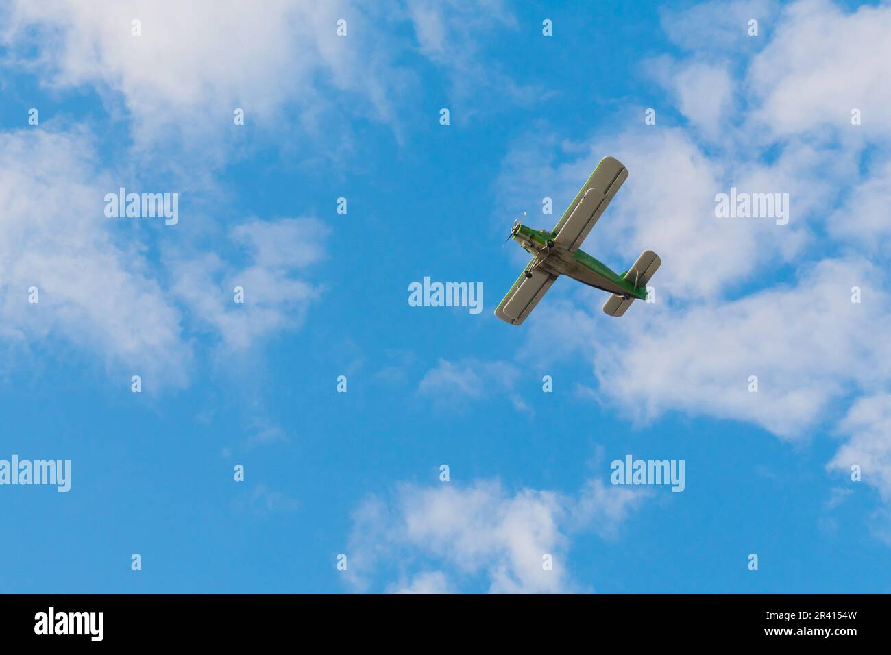 Biplane flying in blue sky and doing stunts during air show Stock Photo ...