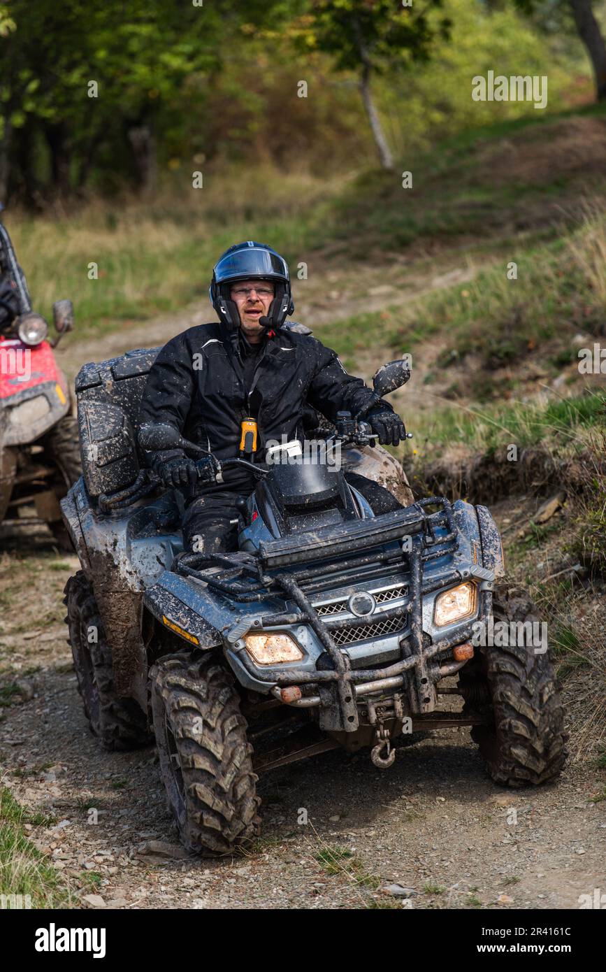 Adventurous driving of ATV motorbikes. A man drives a quad bike on ...