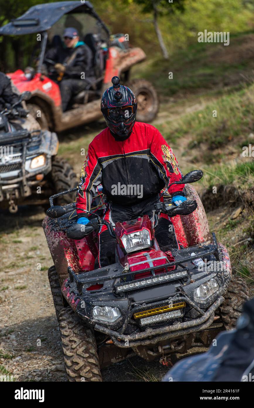 Adventurous driving of ATV motorbikes. A man drives a quad bike on ...