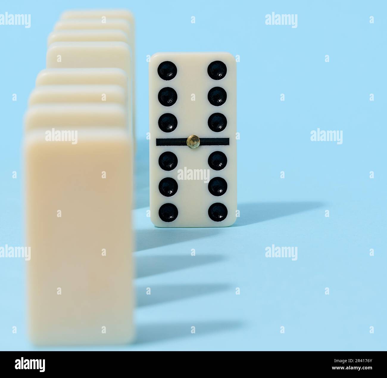 A stack of dominoes on a blue background, an intellectual game Stock ...